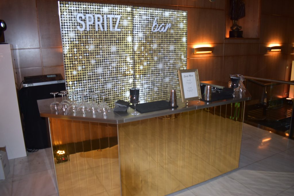 A gold mobile bar and golden event backdrops for this Glitz and Spritz ...